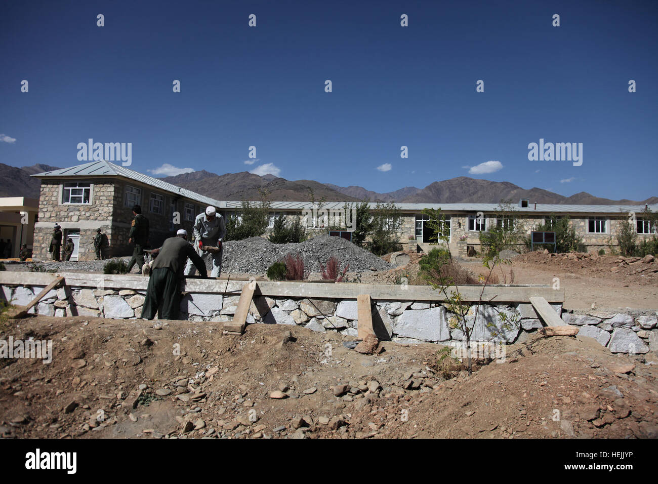 Afghanische Bauarbeiter bauen einen Zaun für eine Schule in Jalrez, in ...