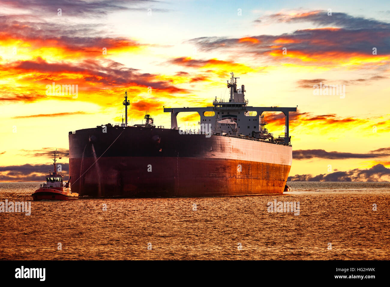 Tanker Schiff mit Begleitung Schlepper am Meer bei Sonnenaufgang ...
