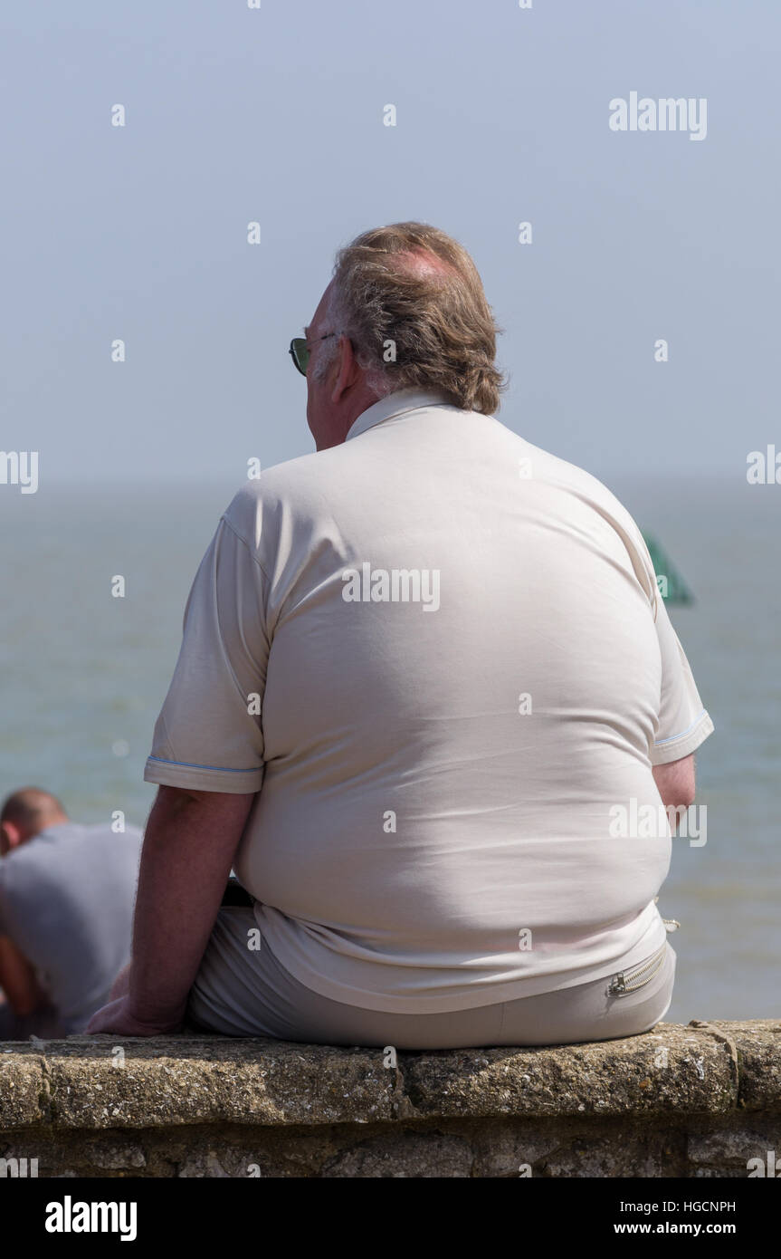 Obese man sitting Stockfotos und -bilder Kaufen - Alamy