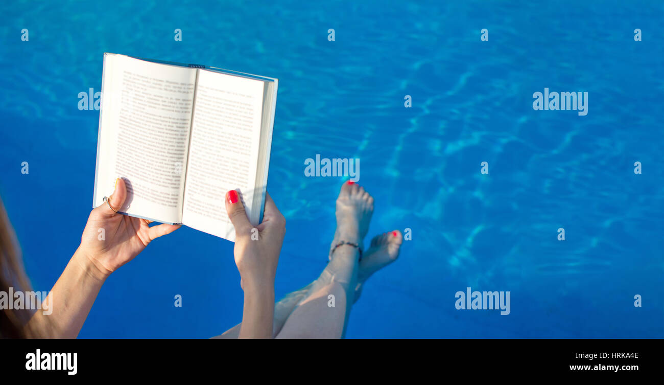 Woman reading book in swimming pool -Fotos und -Bildmaterial in hoher ...