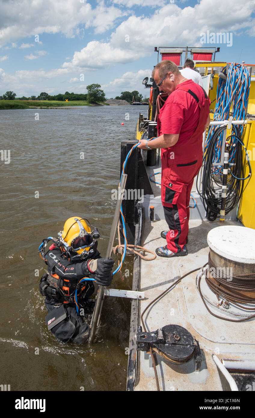 Berufstaucher Olaf Baumann (l) wird von seinem Kollegen Olaf Rademann ...