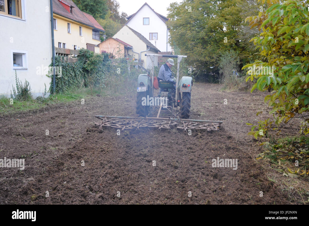 Die Eggen Boden mit alten Traktor Stockfotografie - Alamy