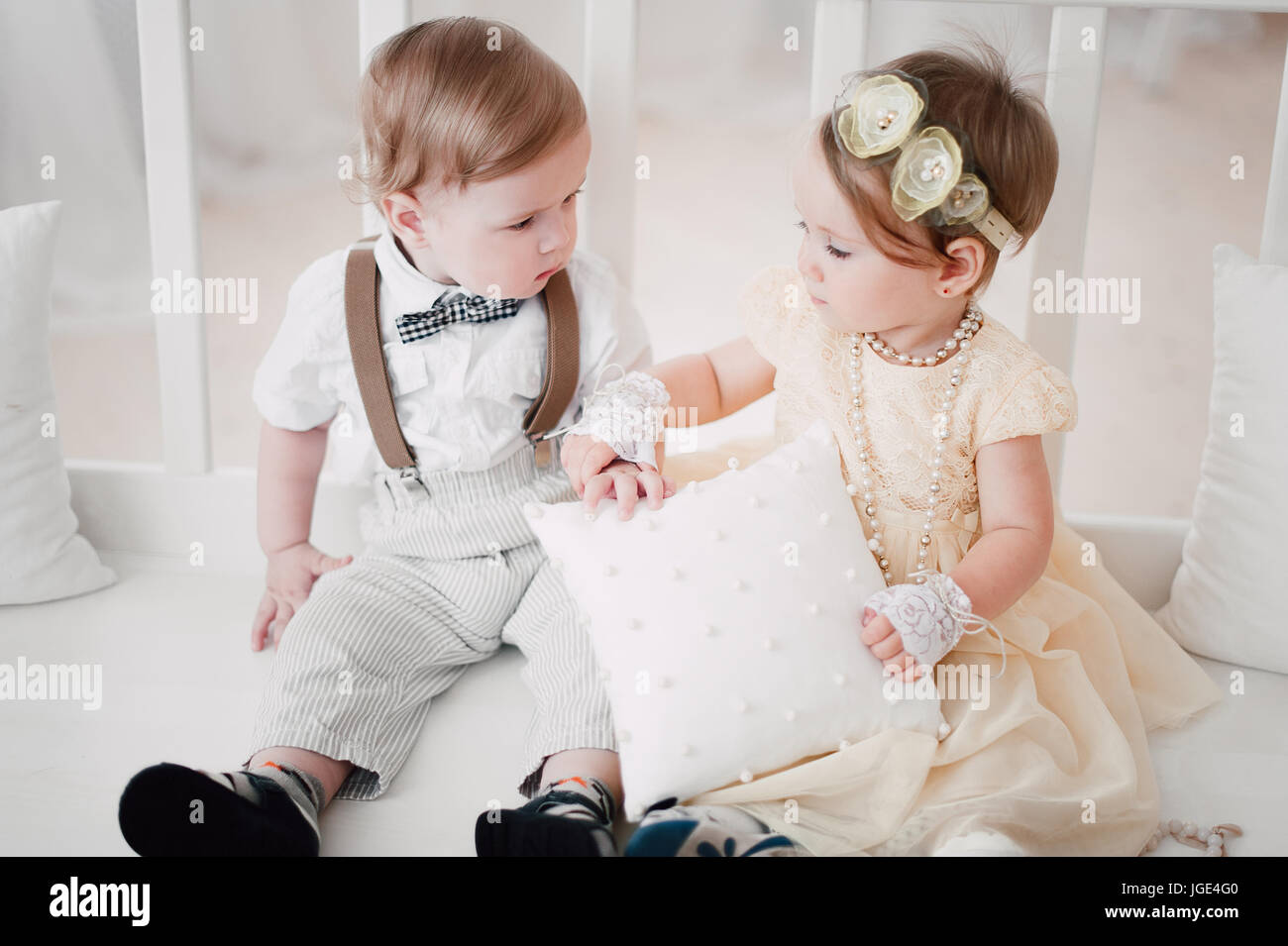 zwei Babys - Jungen und Mädchen verkleidet als Braut und Bräutigam ...