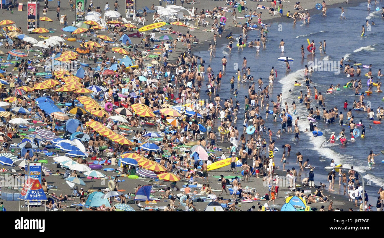 TOKYO, Japan - Menschen ein Sonnenbad am Strand von Enoshima Eastside ...