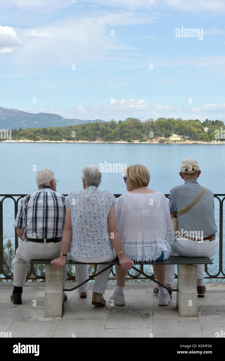 Zwei Ehepaare oder vier Rentner oder ältere Menschen sitzen auf einer Bank mit Blick auf das ...