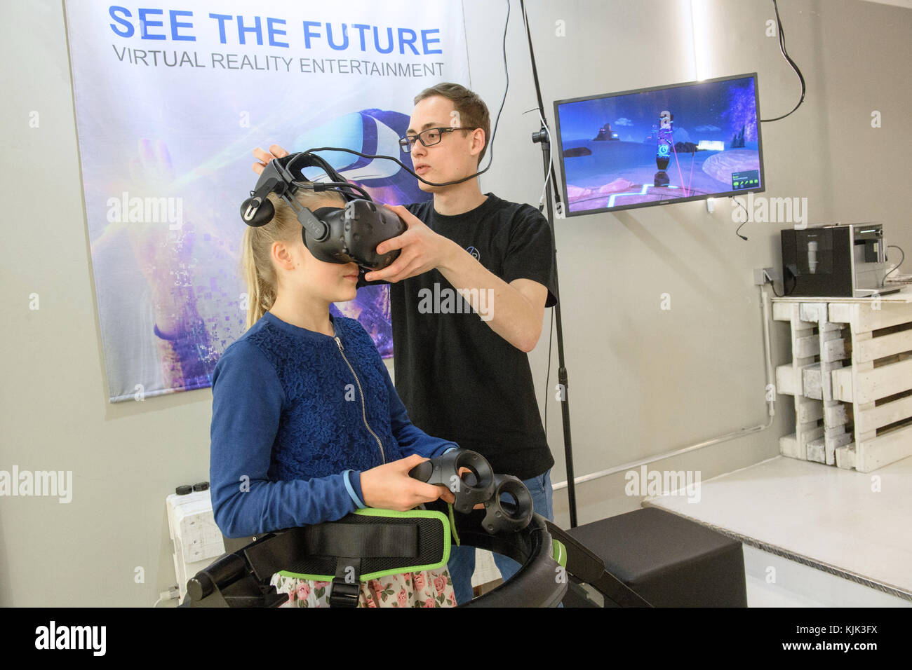 Ein Mitarbeiter der VR Lounge am Potsdamer Platz in Berlin hilft einem ...