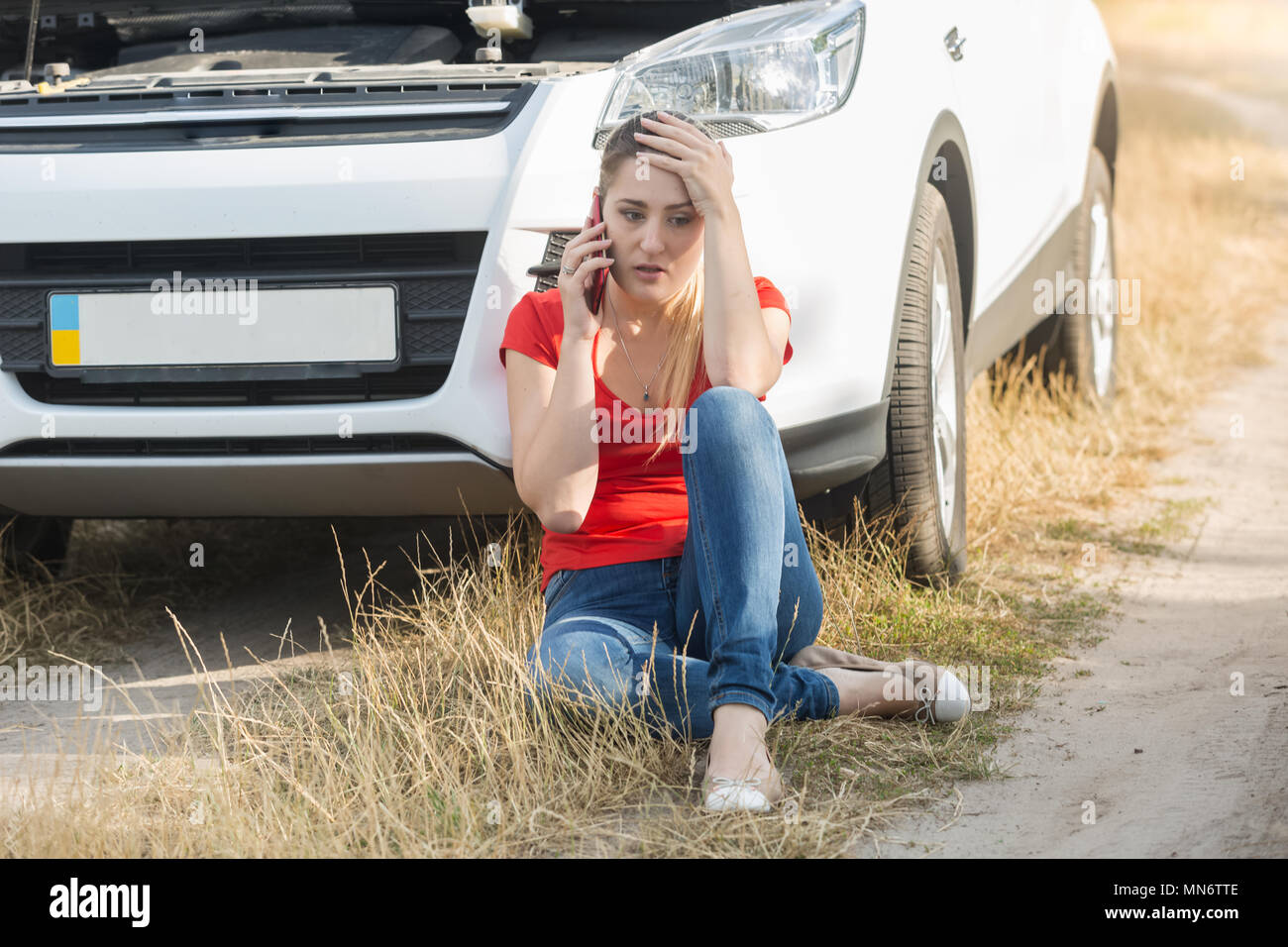 Young woman sitting on car bonnet -Fotos und -Bildmaterial in hoher ...