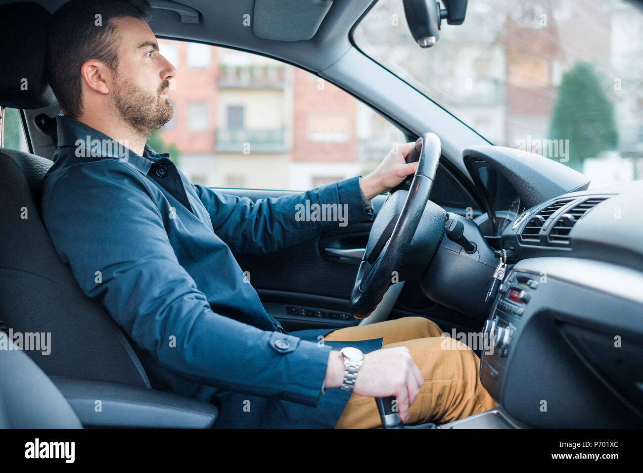 Young man driving expensive car -Fotos und -Bildmaterial in hoher ...