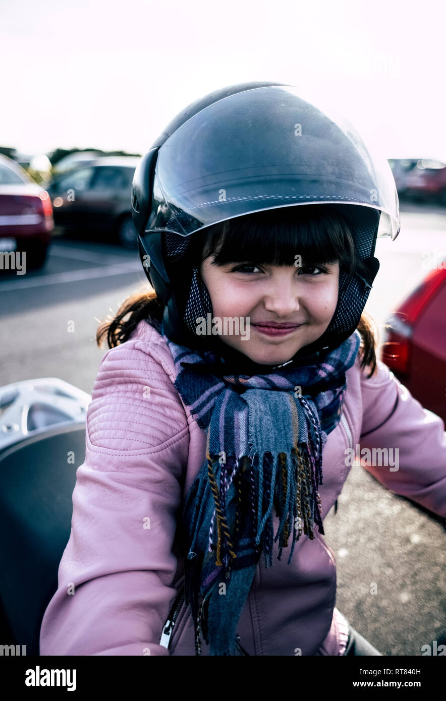 Portrait von lächelnden Mädchen auf einem Motorrad das Tragen von Helm ...