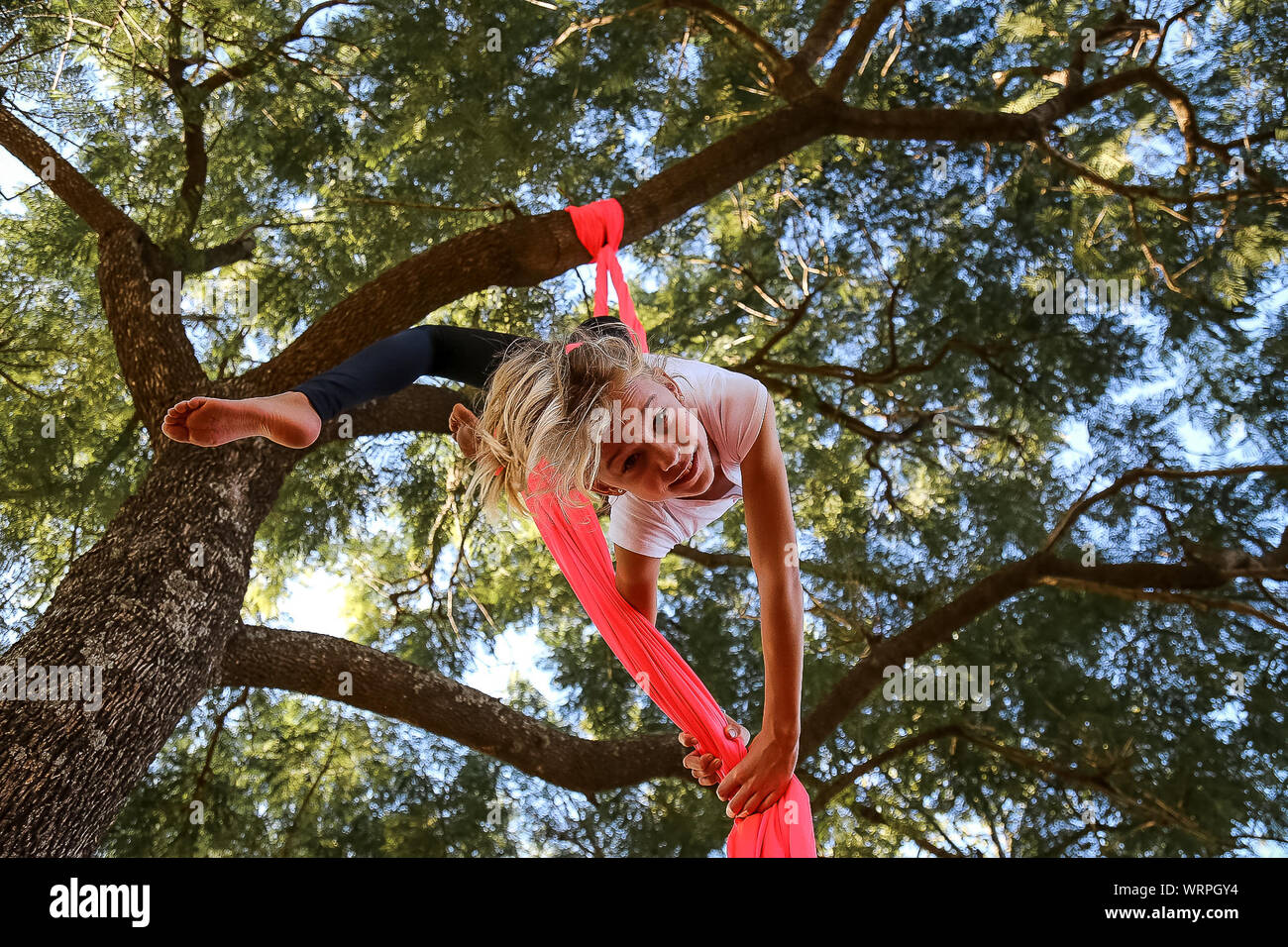 Low angle view girl hanging upside down -Fotos und -Bildmaterial in ...