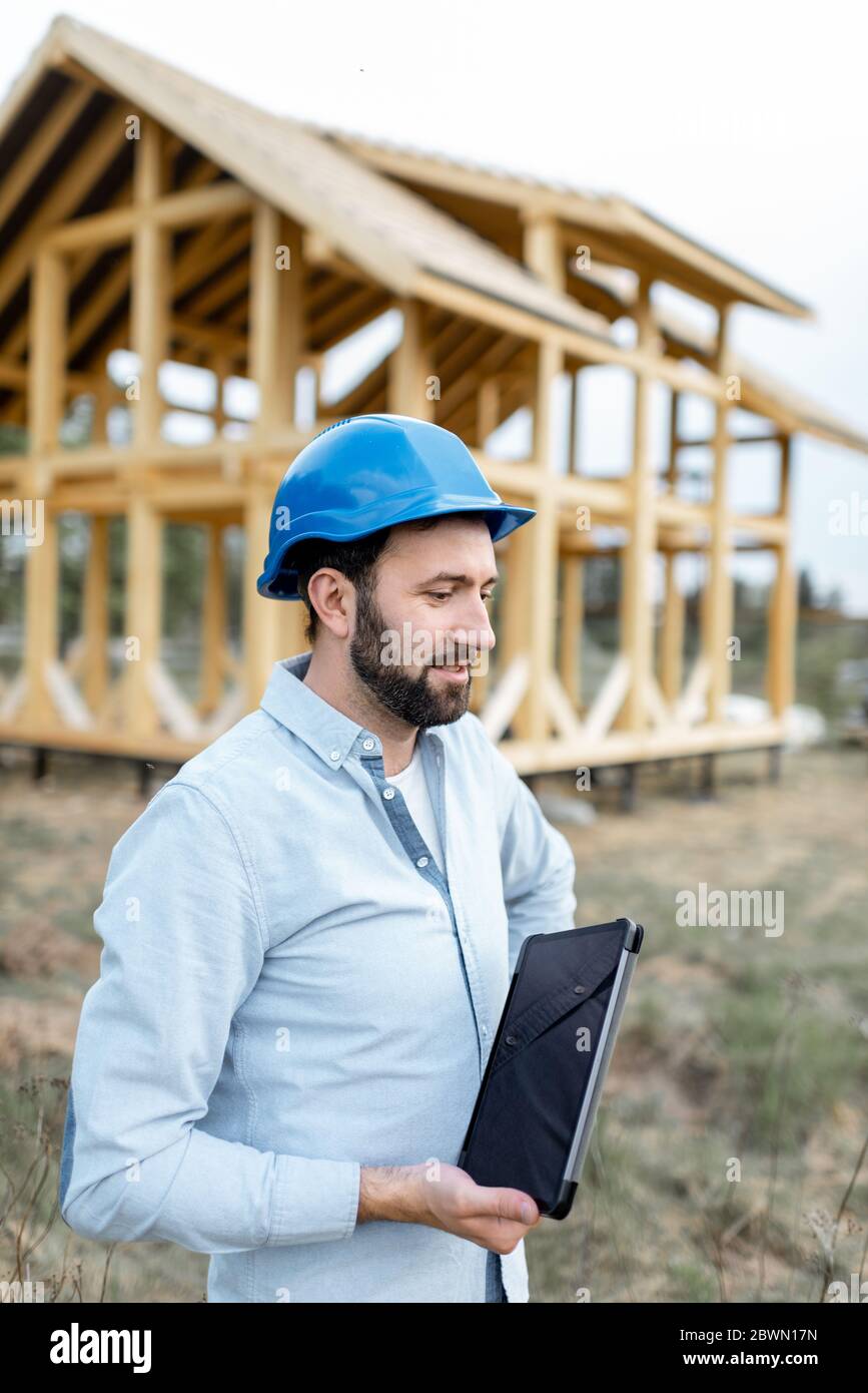 Retrato de un arquitecto o constructor con touchpad digital frente a la ... Retrato de un arquitecto o constructor con touchpad digital frente a la ...