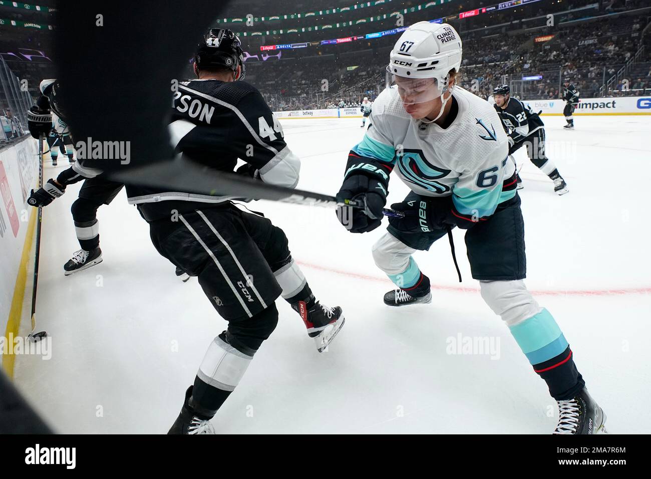 Los Angeles Kings defenseman Mikey Anderson, left, and Seattle Kraken ...