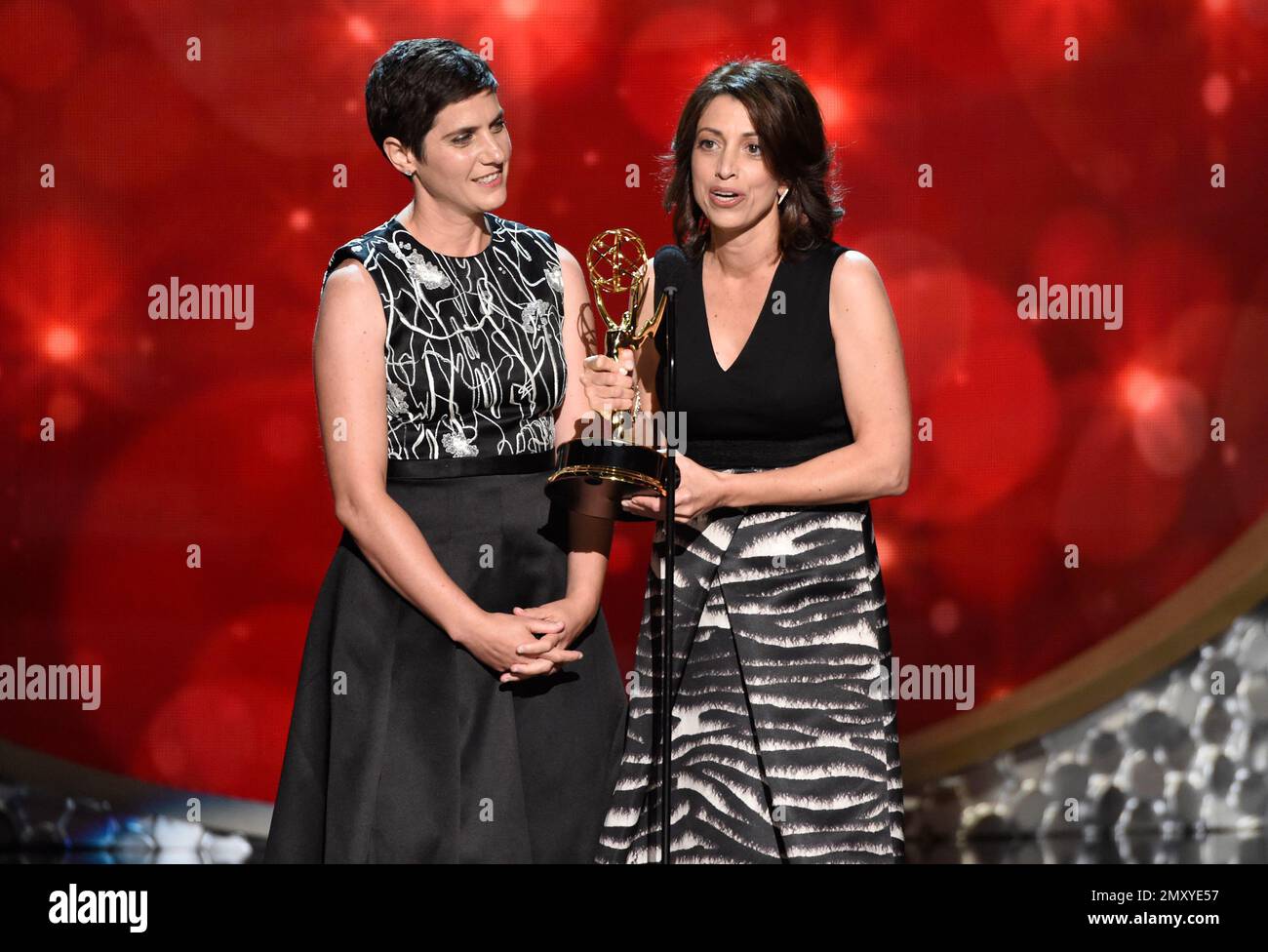 Laura Ricciardi, left, and Moira Demos accept the award for outstanding ...