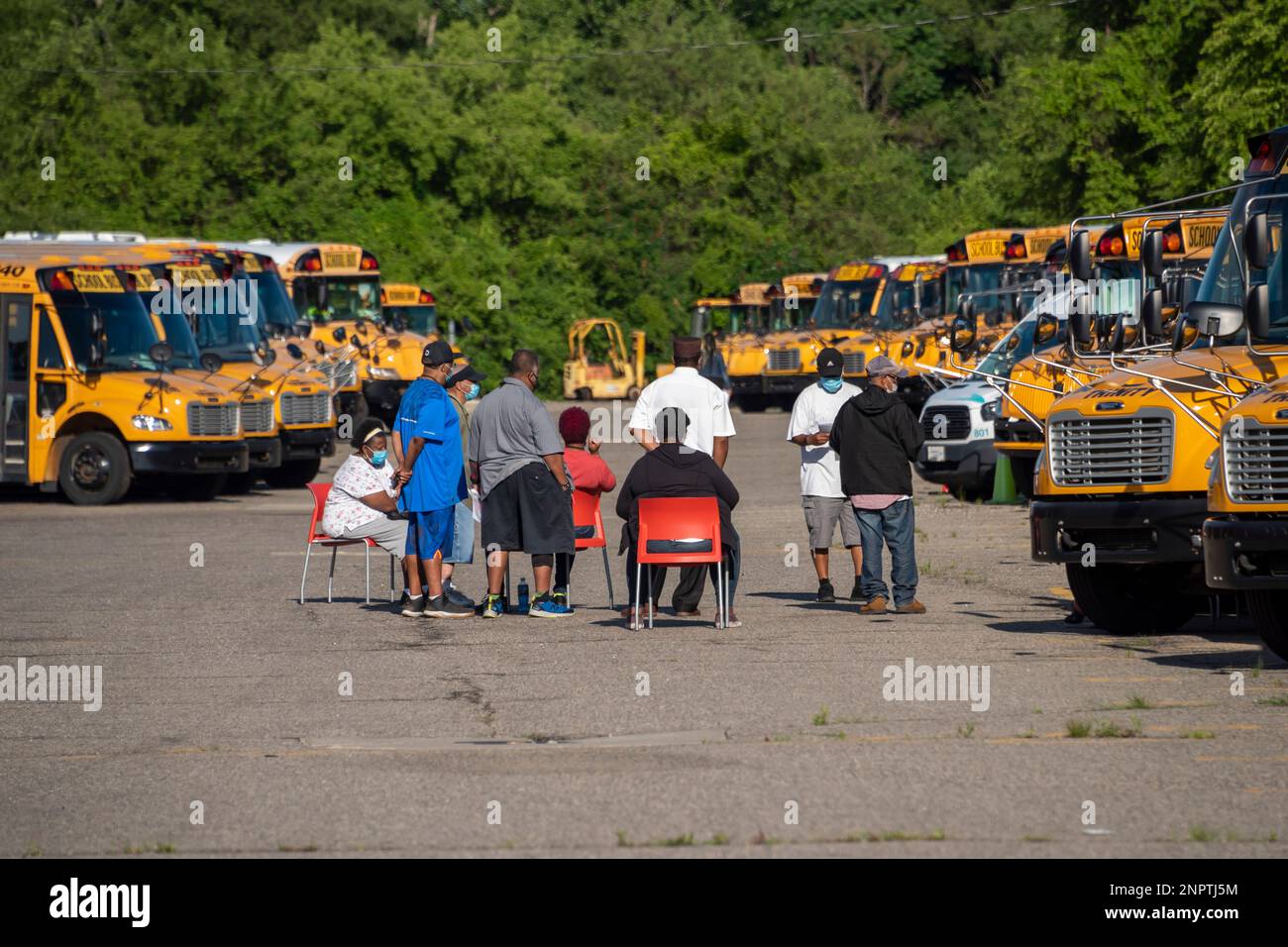 Workers sit around dozens of idle school buses after demonstrators ...