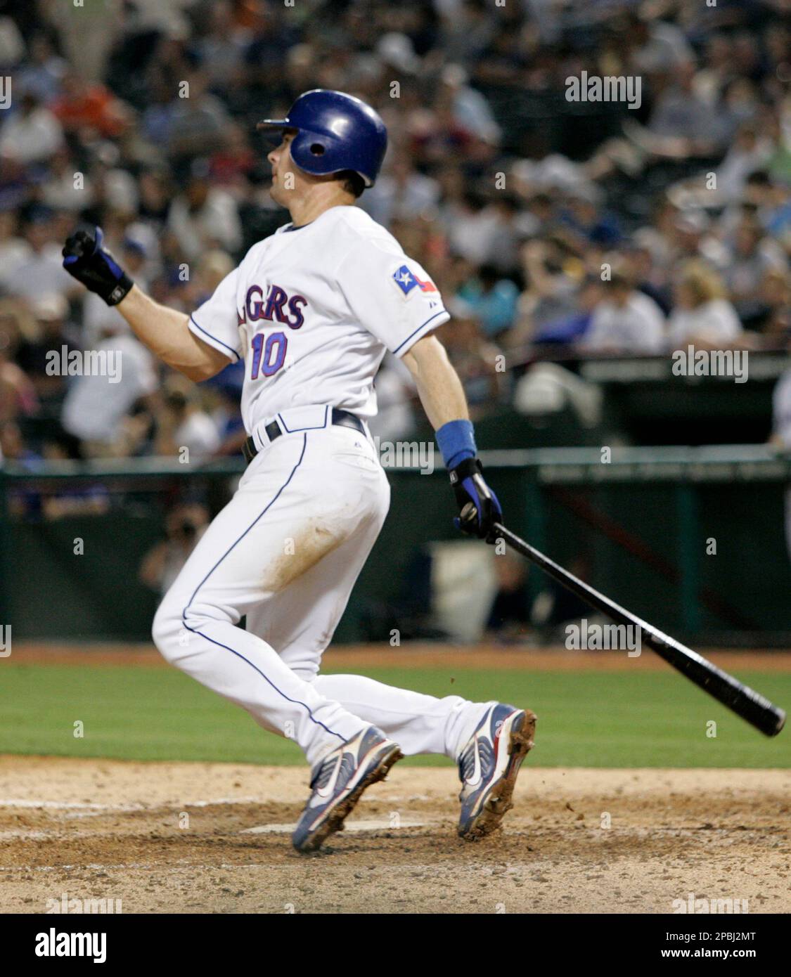 Texas Rangers' Michael Young (10) follows through on a single off of ...