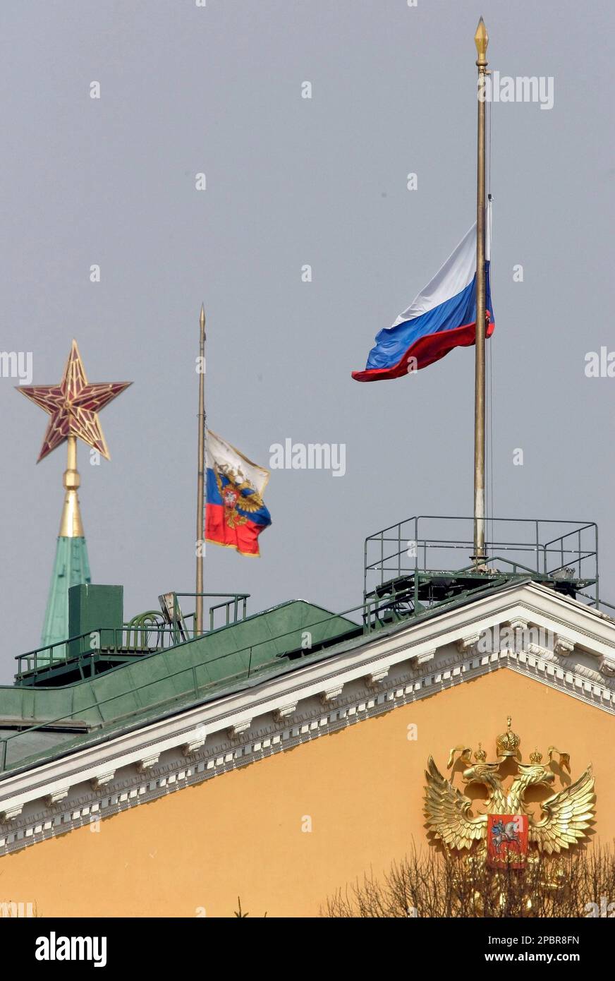 A Russian Flag Right And Presidents Colour Are At Half Staff Above