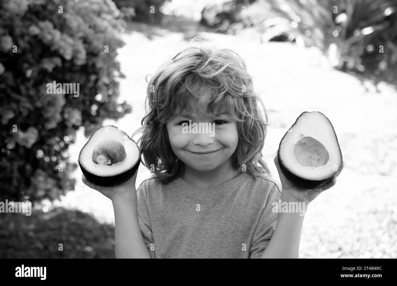 Feliz Niño Mostrando Aguacate En El Jardín De Verano Comida Sana Para Niños Fotografía De Stock