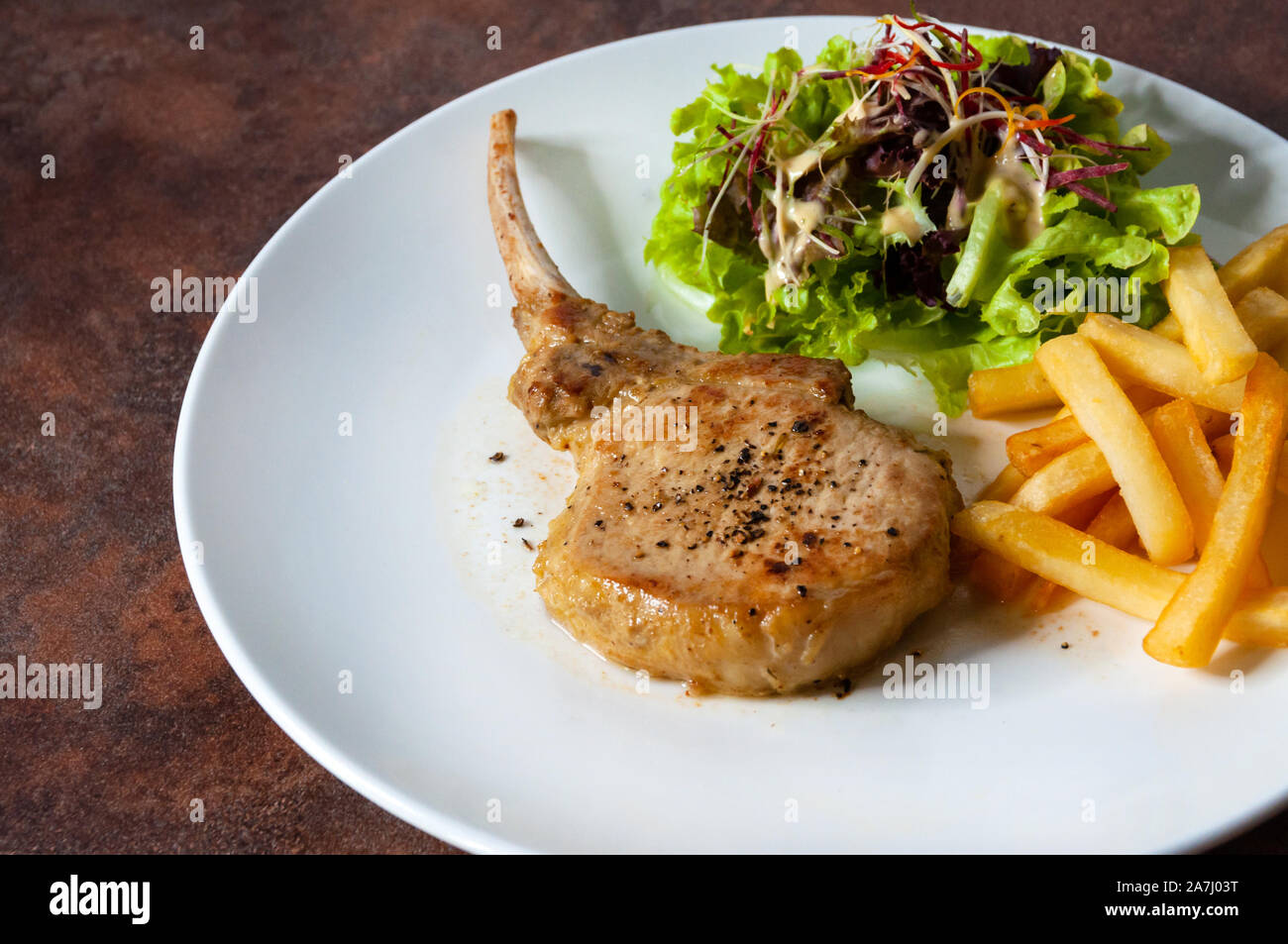 Côtelette de porc rôti de longe de porc grillé, servi dans un plat ...