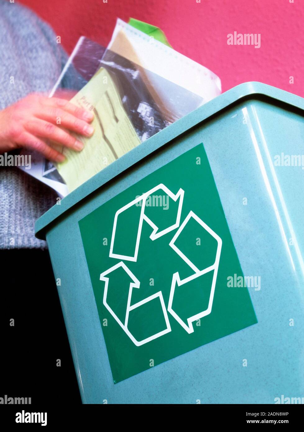 Bac de recyclage. Personne qui met le papier dans un bac de recyclage ...