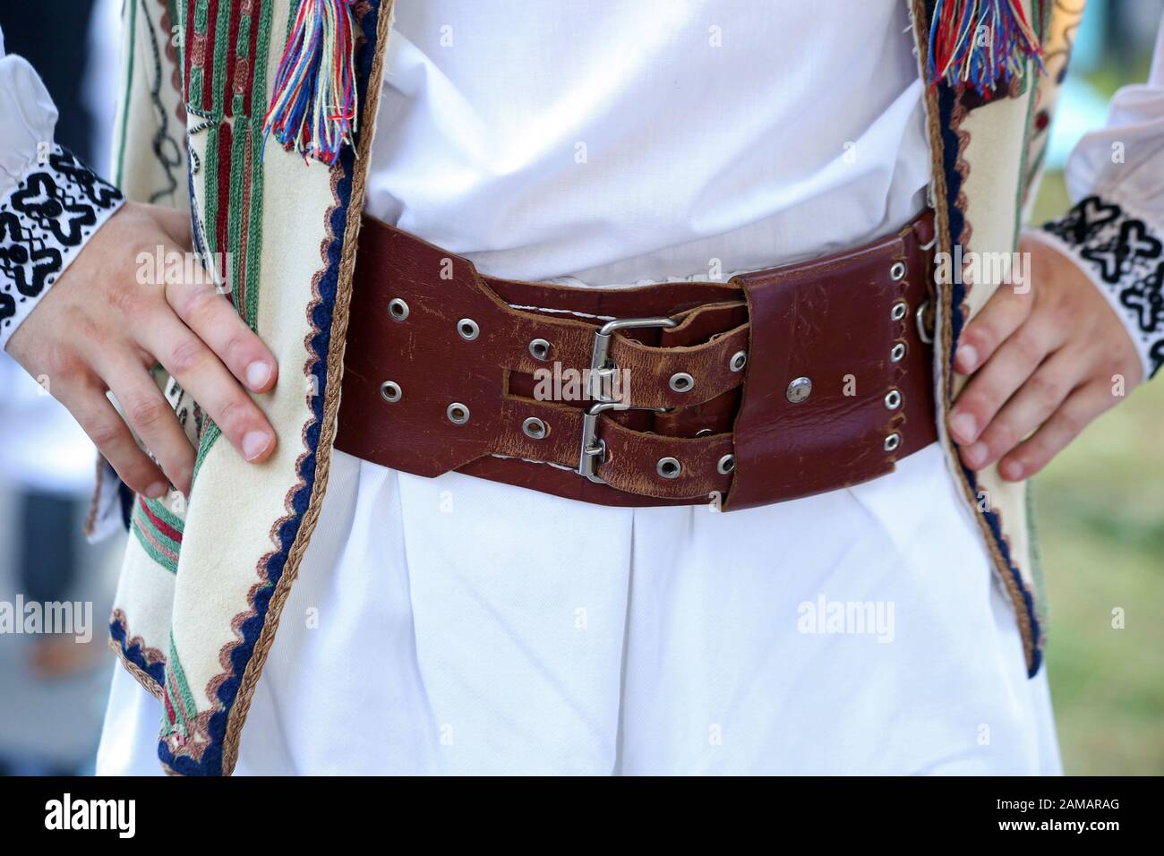 L'artiste folklorique joue du saxophone portant un beau costume ...