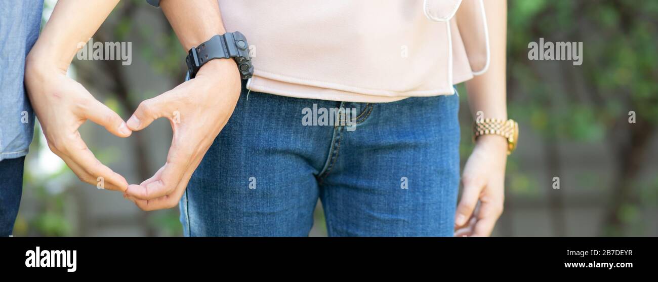 Beau heureux jeune couple amusant faire le geste de forme de coeur avec ...