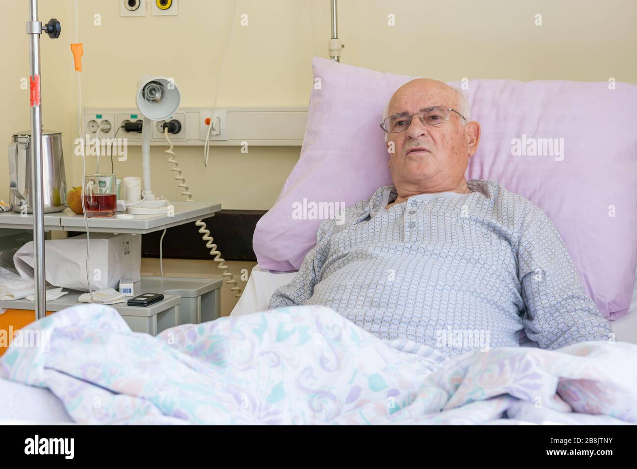 Homme malade pose dans un lit hopital Banque de photographies et d ...