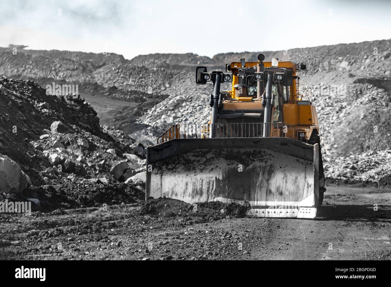 Le bulldozer nivelant la route avec la niveleuse après l'explosion du ...