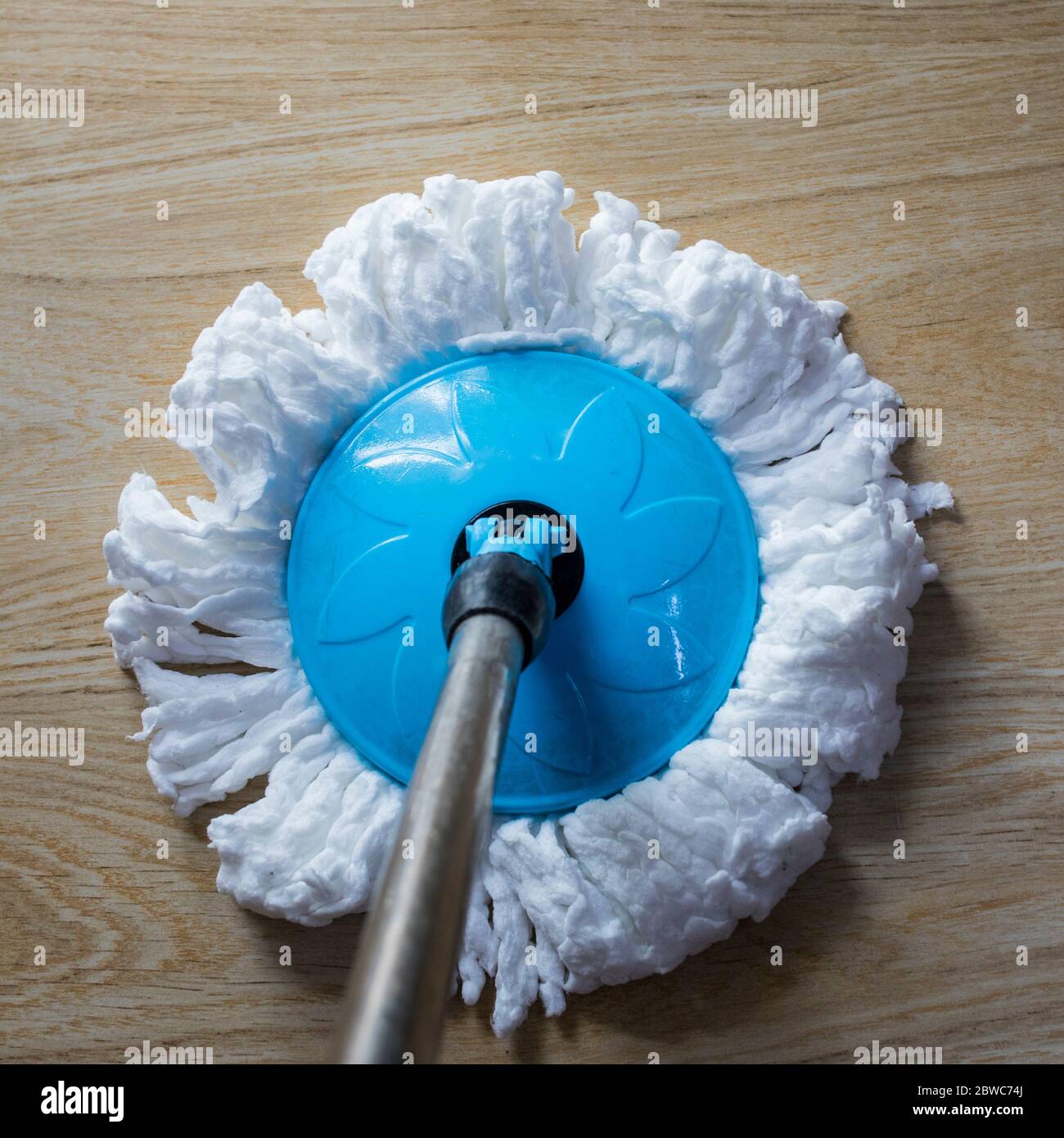 Un balai à franges rond avec tête en microfibre sur sol en carreaux de ...