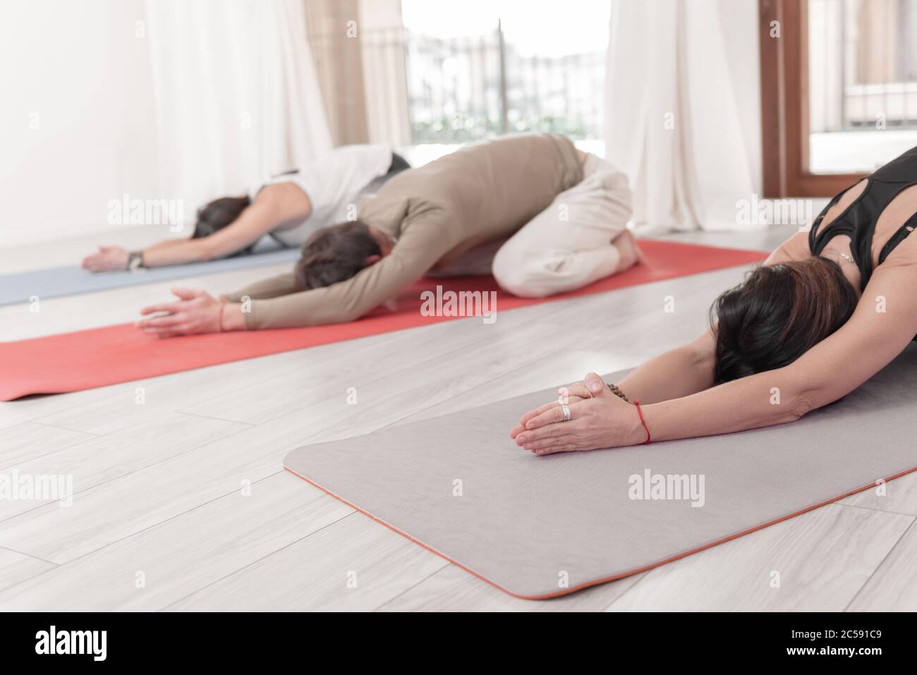 Groupe de personnes pratiquant le yoga. Position Shashankasana. Posture ...