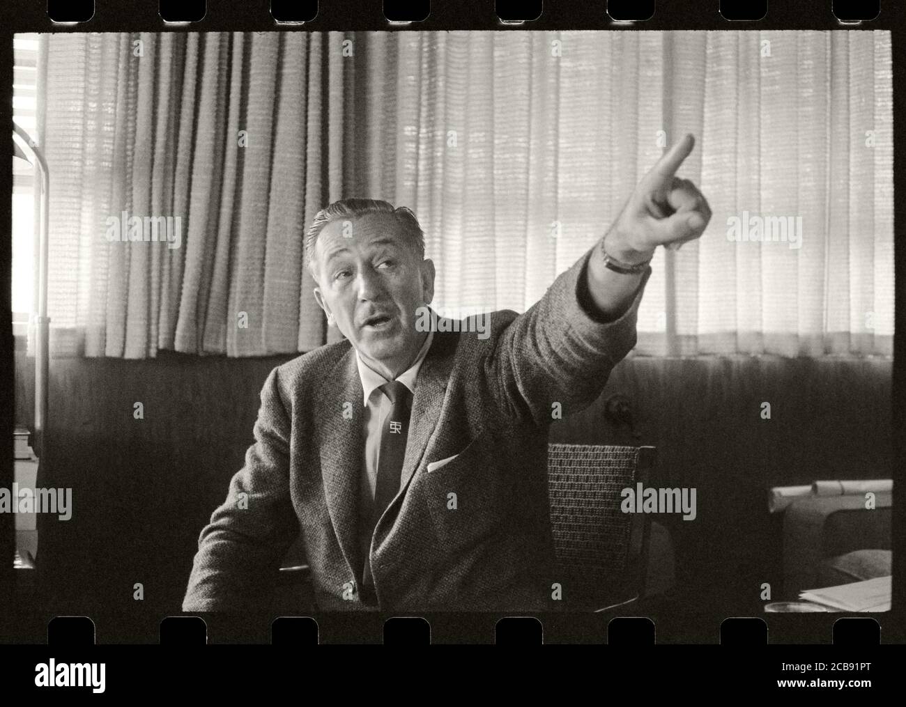 Le pionnier du cinéma, Walt Disney, montre son doigt vers le haut en ...