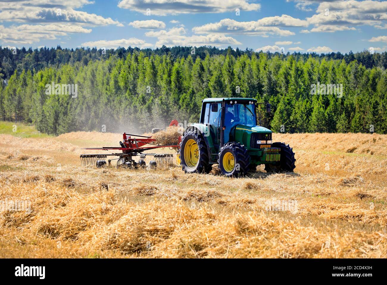 Agriculteur travaillant dans les champs avec un tracteur John Deere ...
