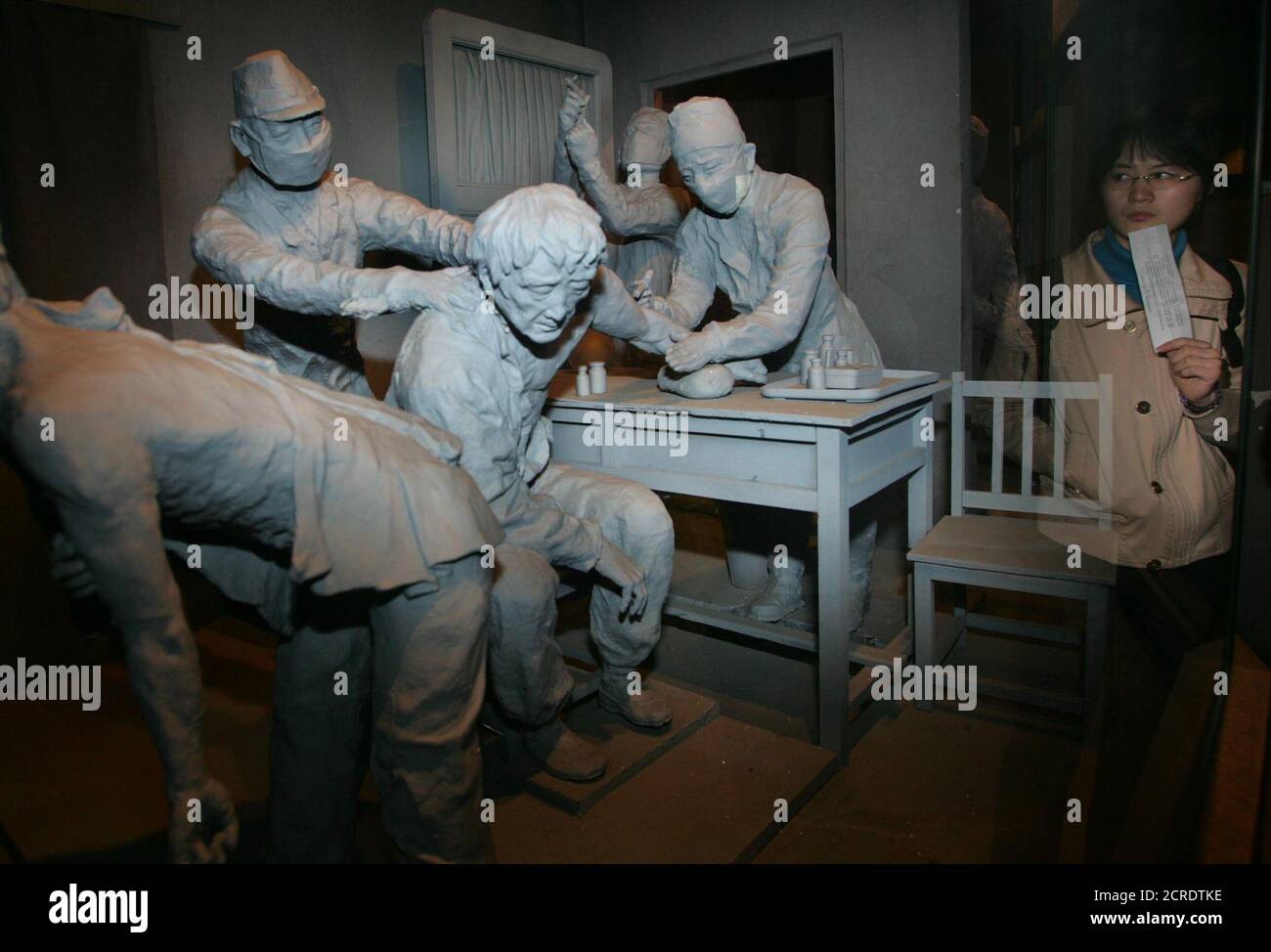 A Chinese student views a sculpture depicting Japanese soldiers holding ...