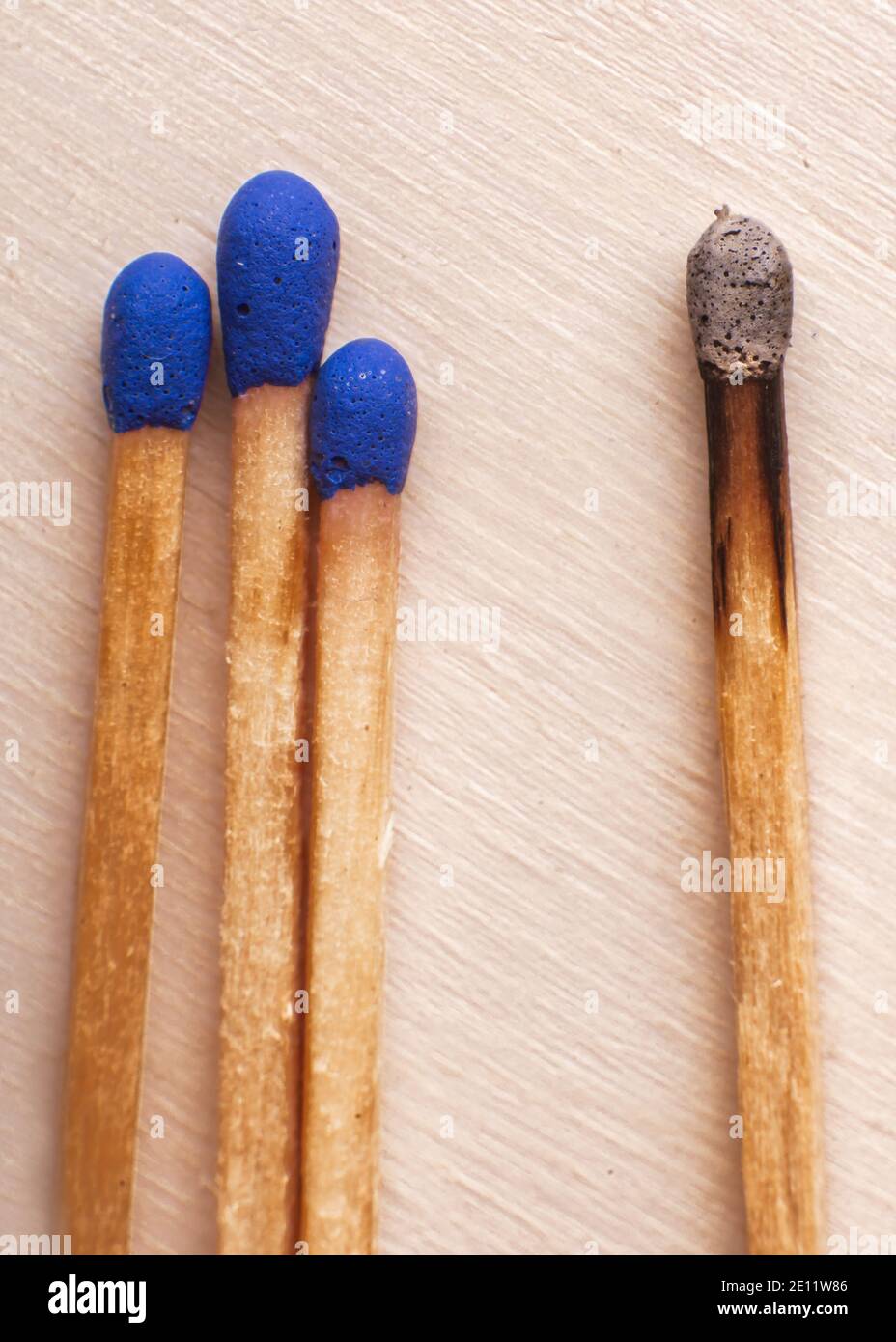 Trois allumettes sur fond de bois à côté de l'allumette brûlée. Symbole ...