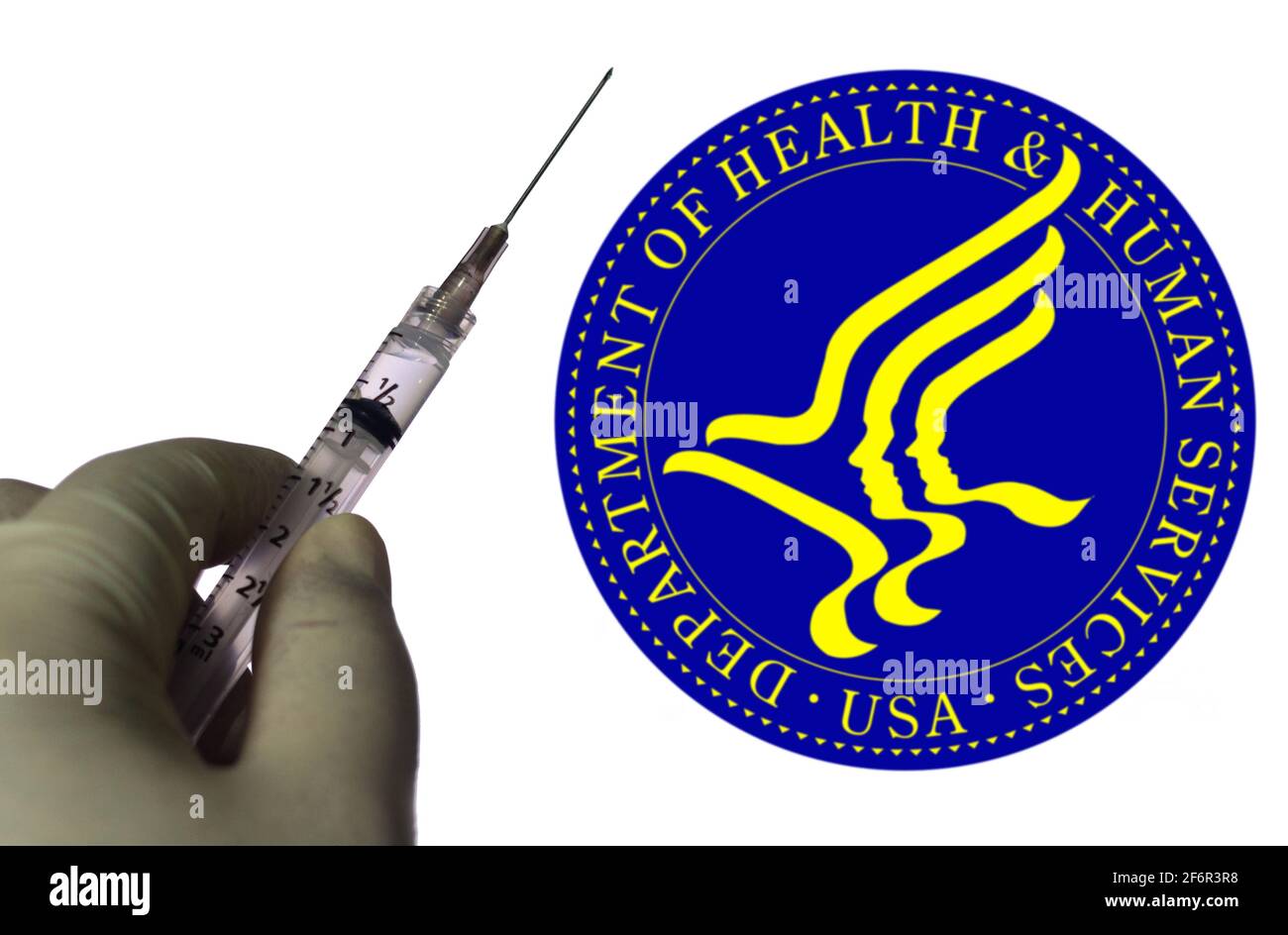 Dans cette illustration, une main tient une seringue médicale avec le ...