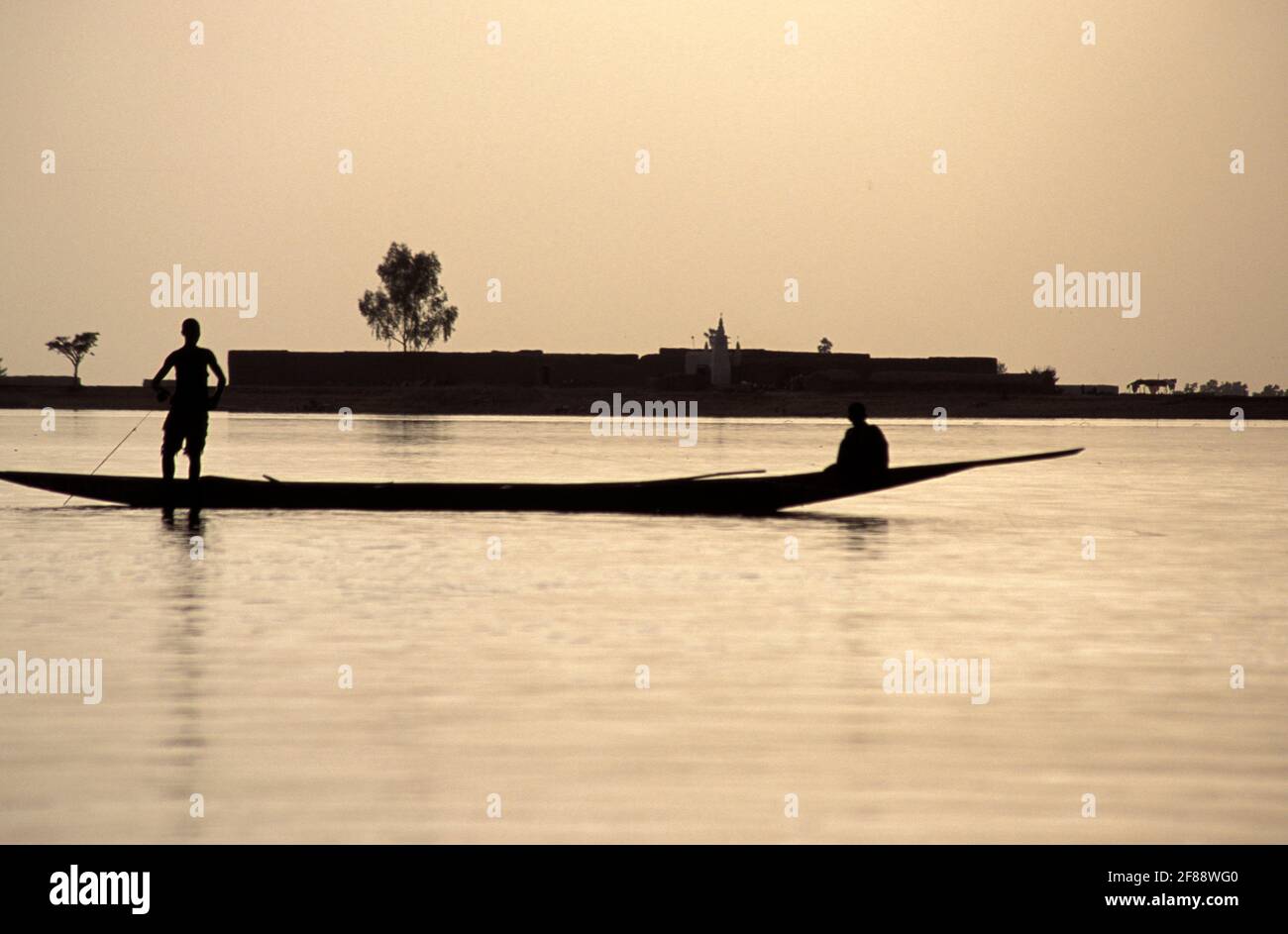 Transport de personnes dans un pirogue dans le fleuve Niger au coucher ...
