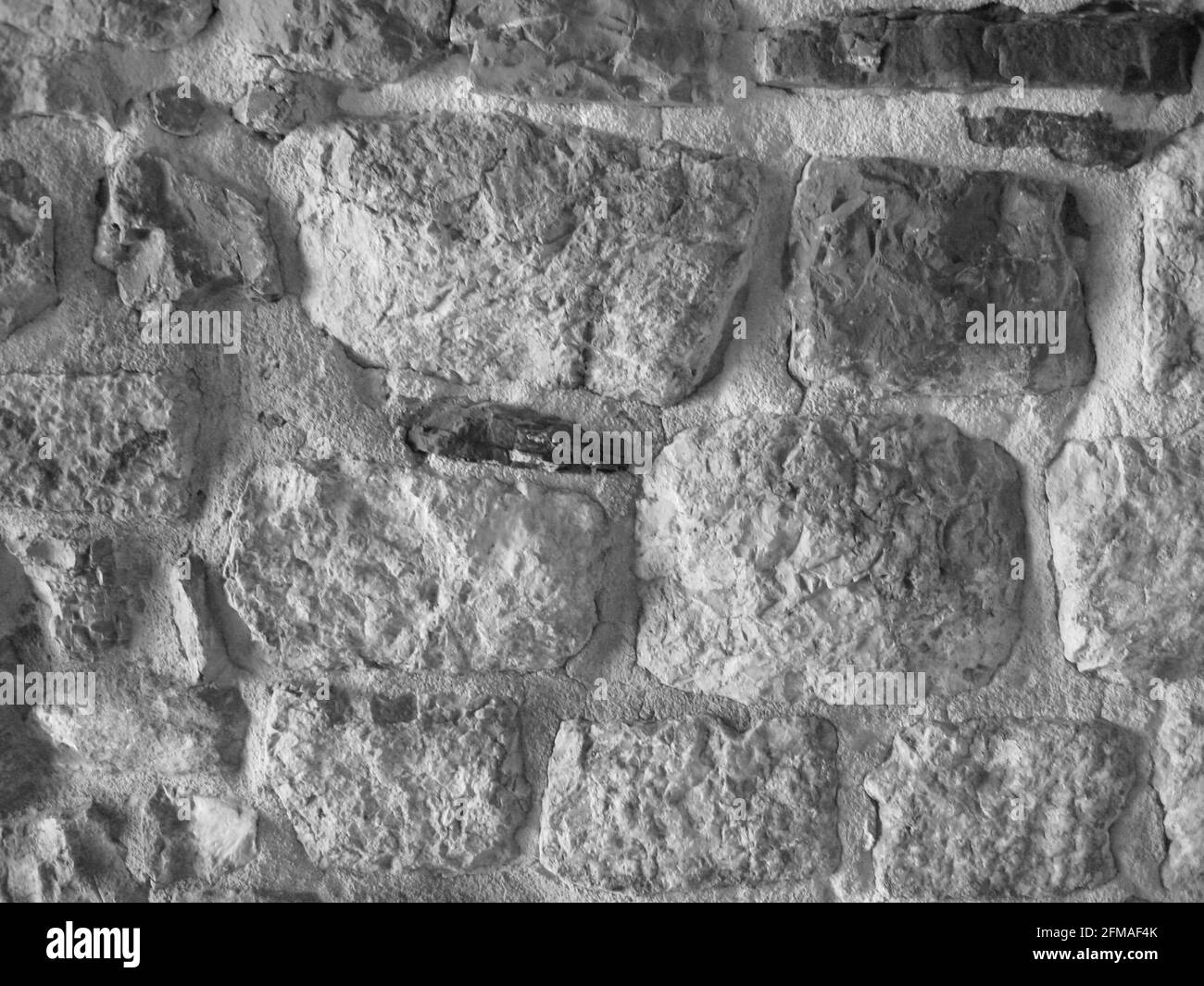 Gros plan sur le château de mur en pierre. C'est un mur rugueux en ...