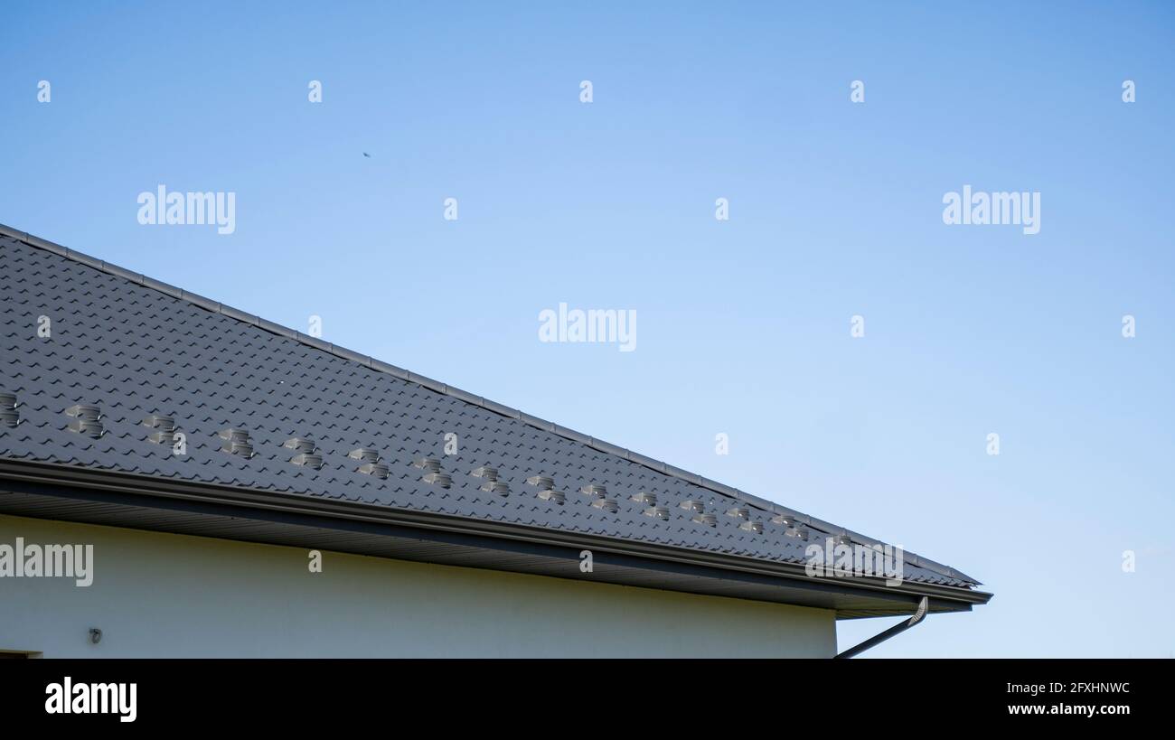Toit à profil métallique gris ondulé installé dans une maison moderne ...