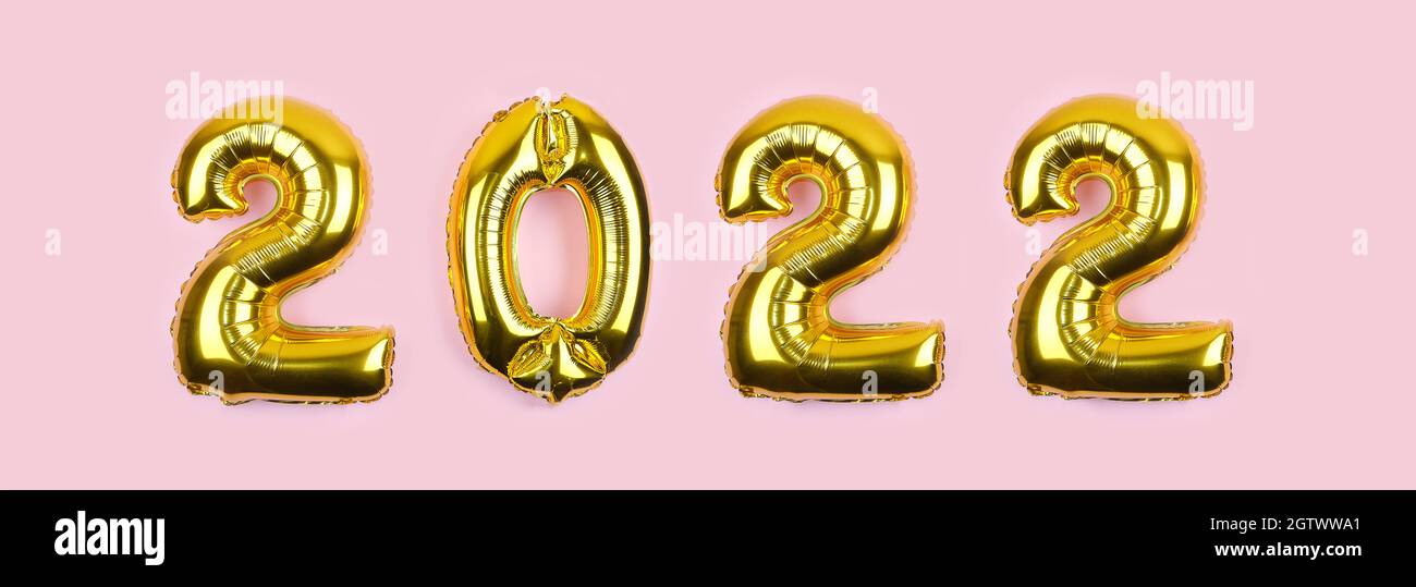 2022 banderoles avec ballons dorés sur fond rose. Numéros 2022 ballons ...