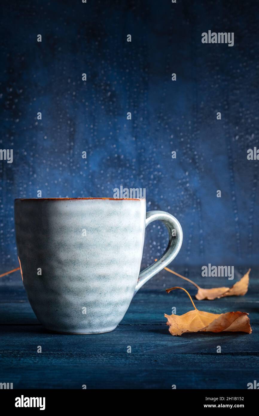 Ambiance automnale.Une tasse de thé et des feuilles d'automne devant ...