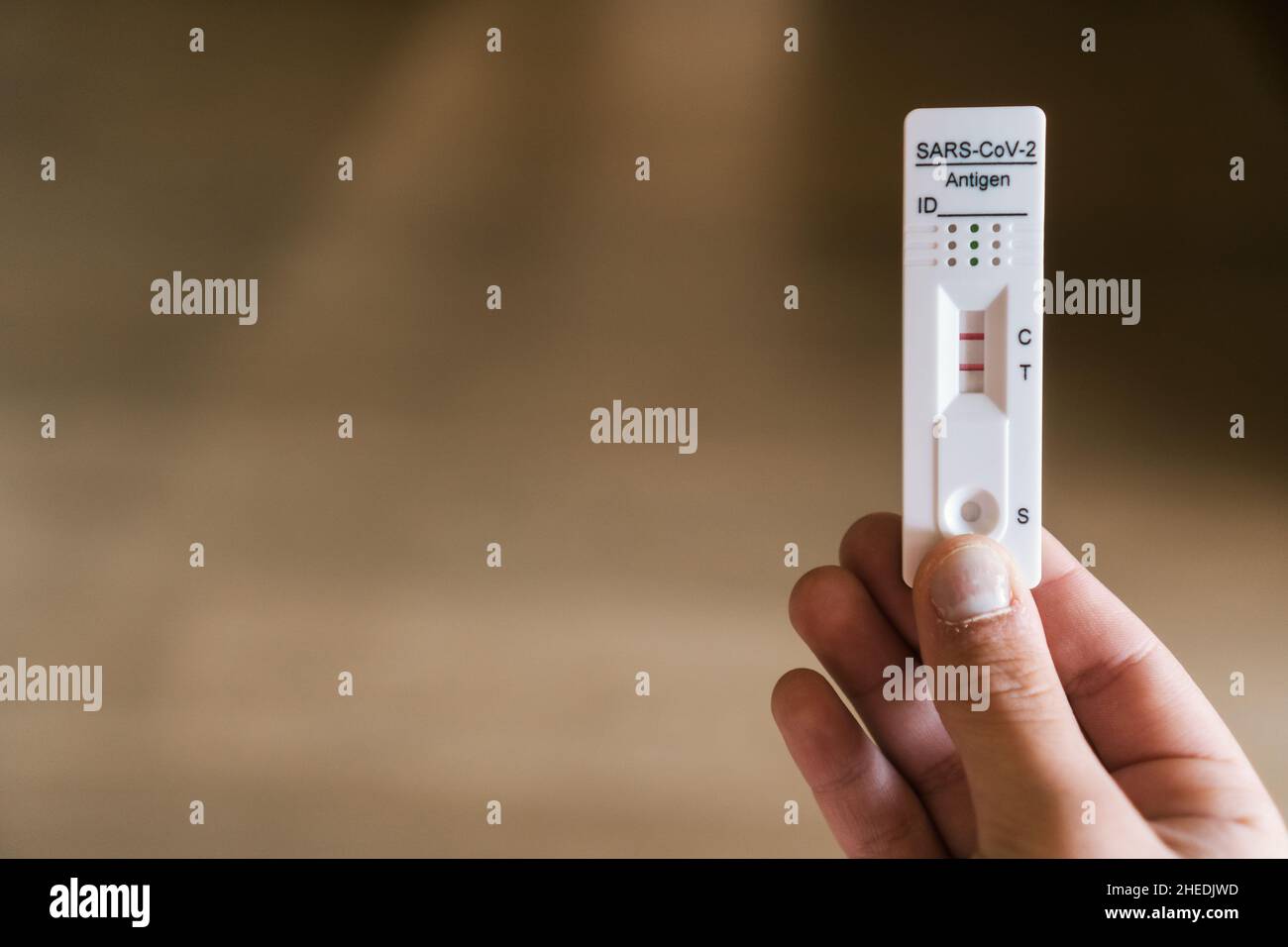 Une main de fille contenant le kit de test rapide d'antigène avec un ...