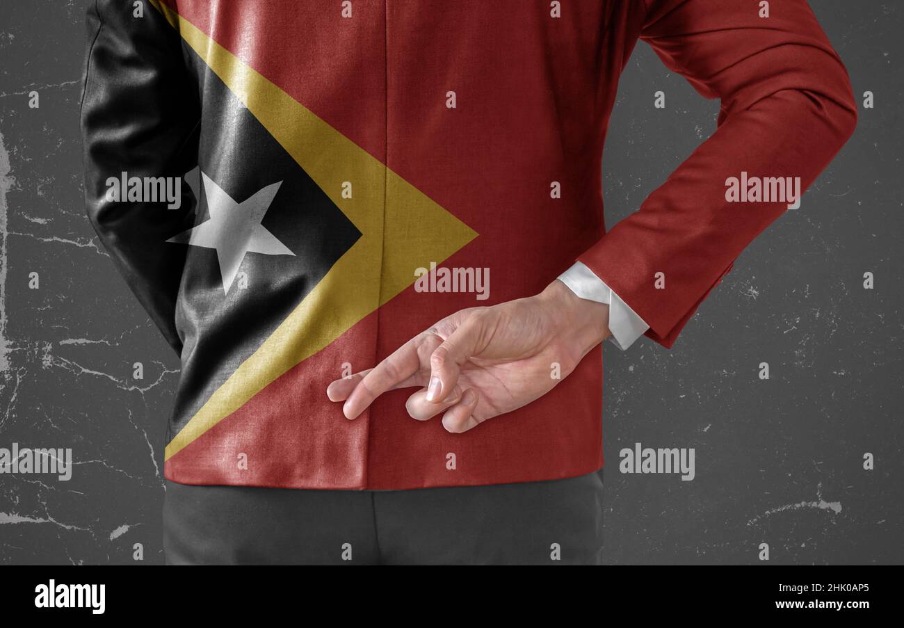 Veste d'homme d'affaires avec drapeau du Timor oriental avec ses doigts ...