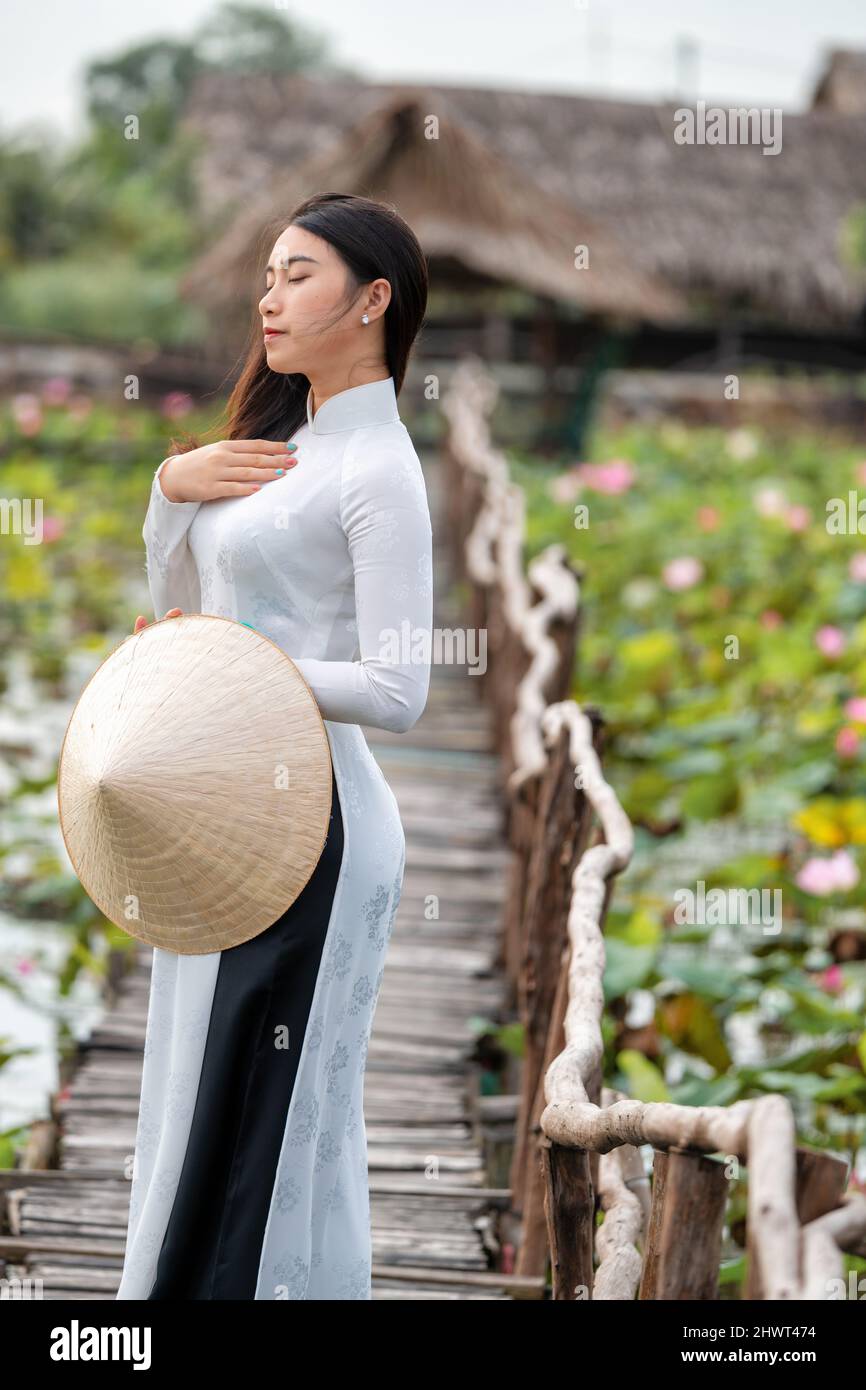 Portrait de la belle femme vietnamienne avec chapeau traditionnel ...