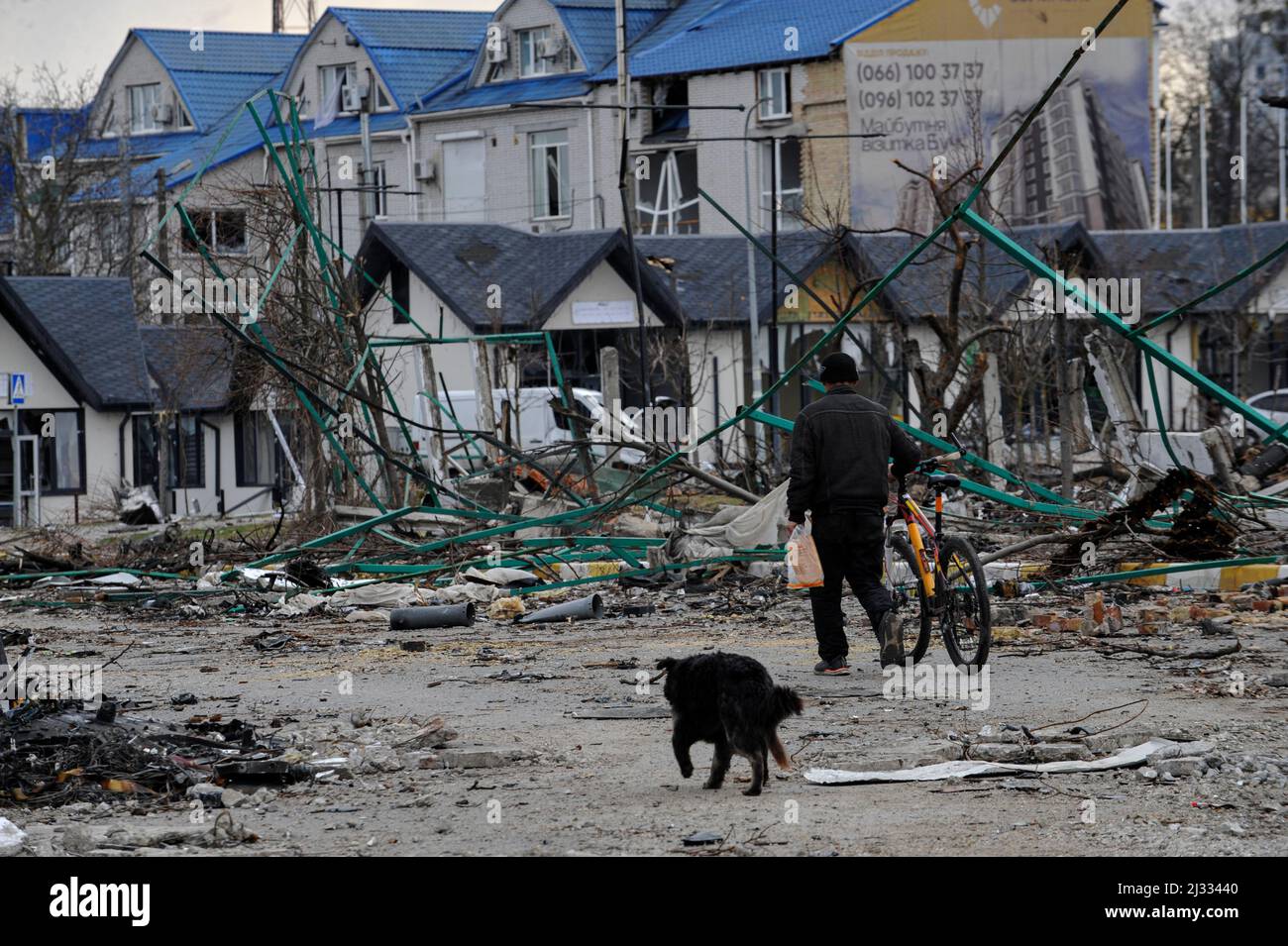 Un homme marche dans la rue avec la toile de fond de la destruction ...