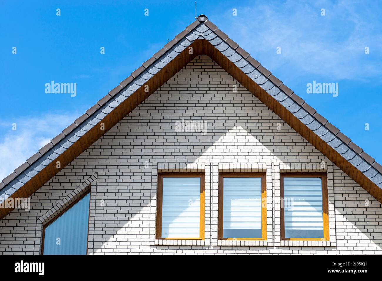L'église a une façade classique en brique blanche et un toit conique ...