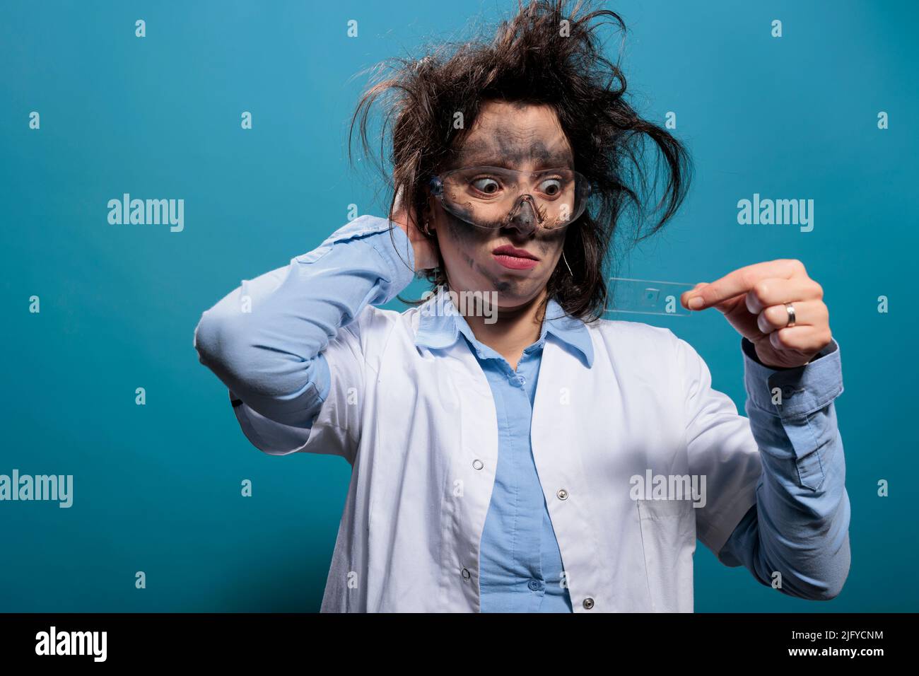 Scientifique fou avec cheveux désordonnés et visage sale regardant ...