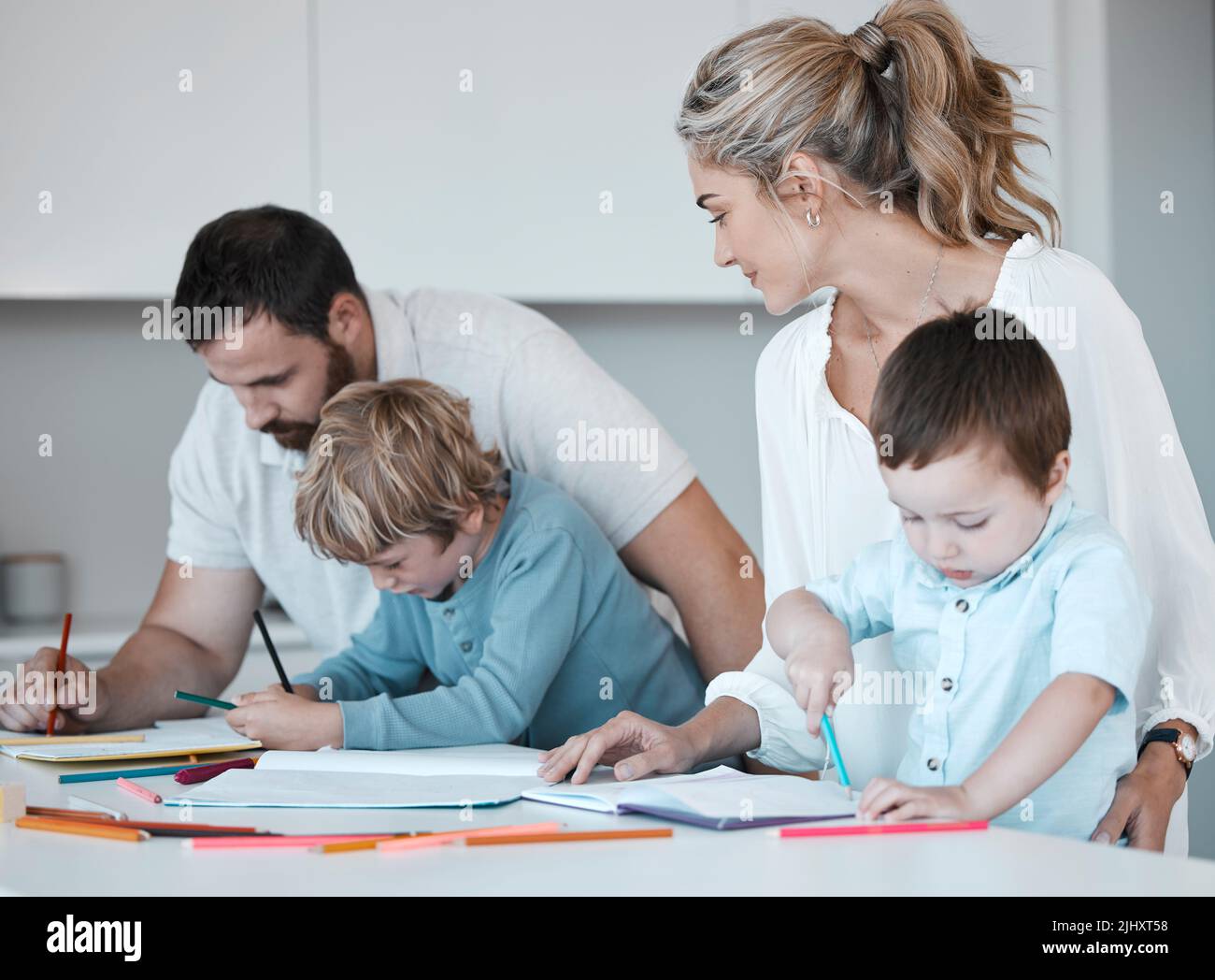 Jeune famille caucasienne assise à la maison. Parents aimant aidant ...