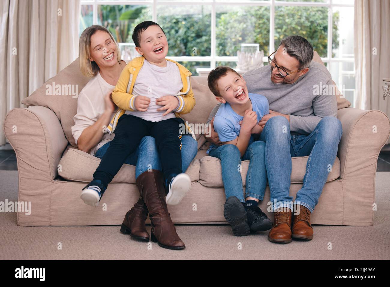 Couple sitting sofa female tickling male Banque de photographies et d ...