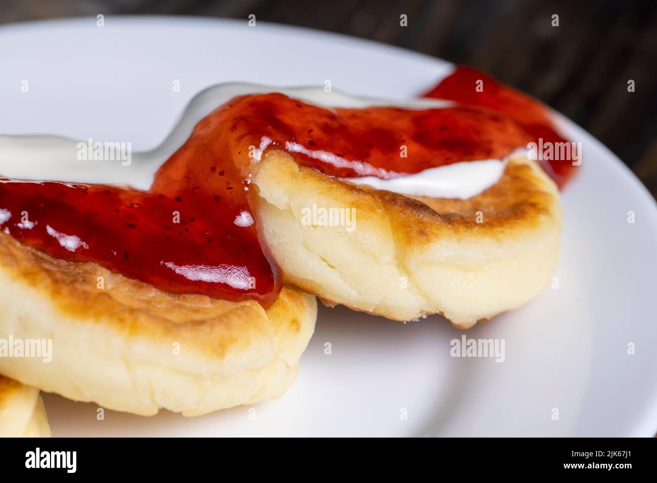 les gâteaux au fromage cottage sont mangés avec de la crème aigre ou de ...