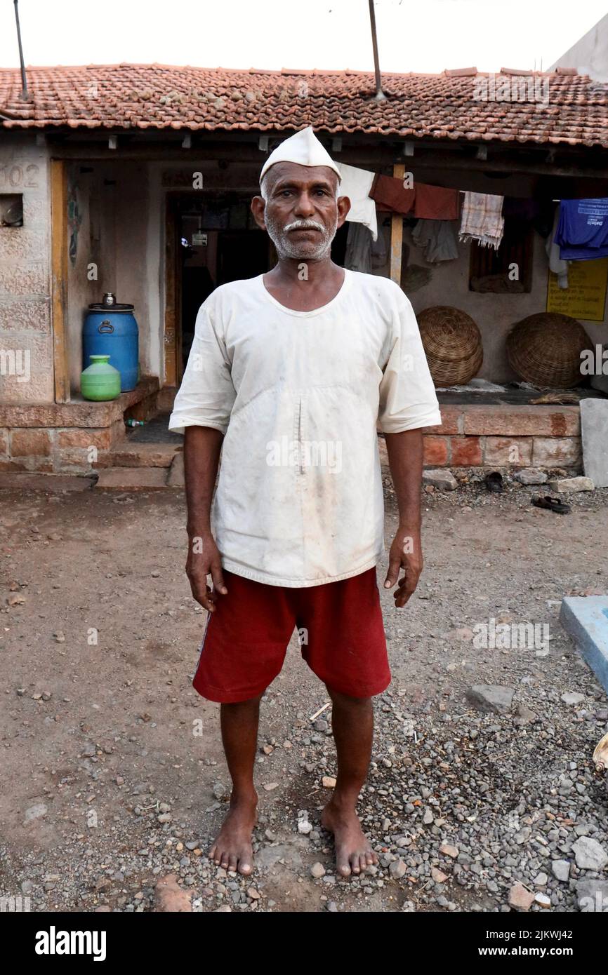 A beautiful portrait of an old South Indian village man or farmer wearing marathi cap and ...