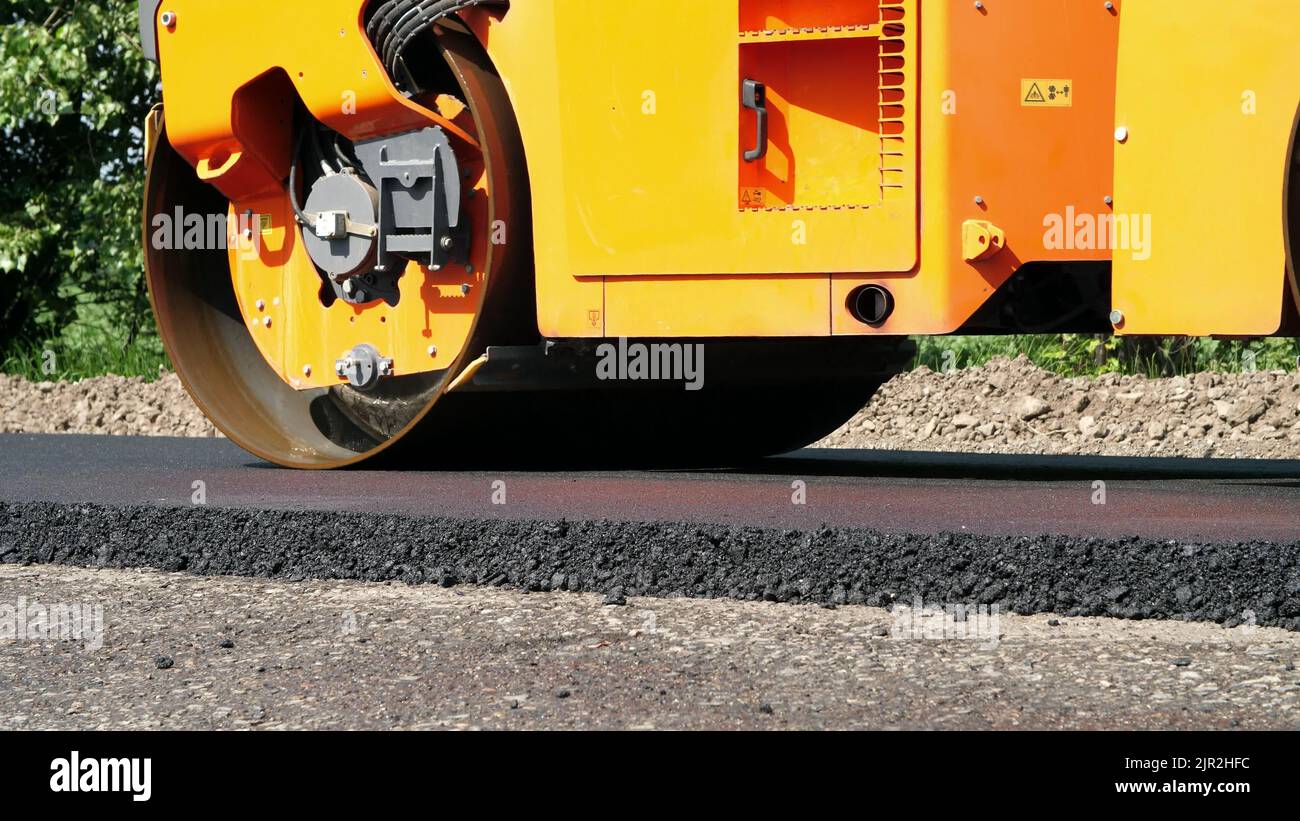 En gros plan, la construction de routes fonctionne avec une machine à ...